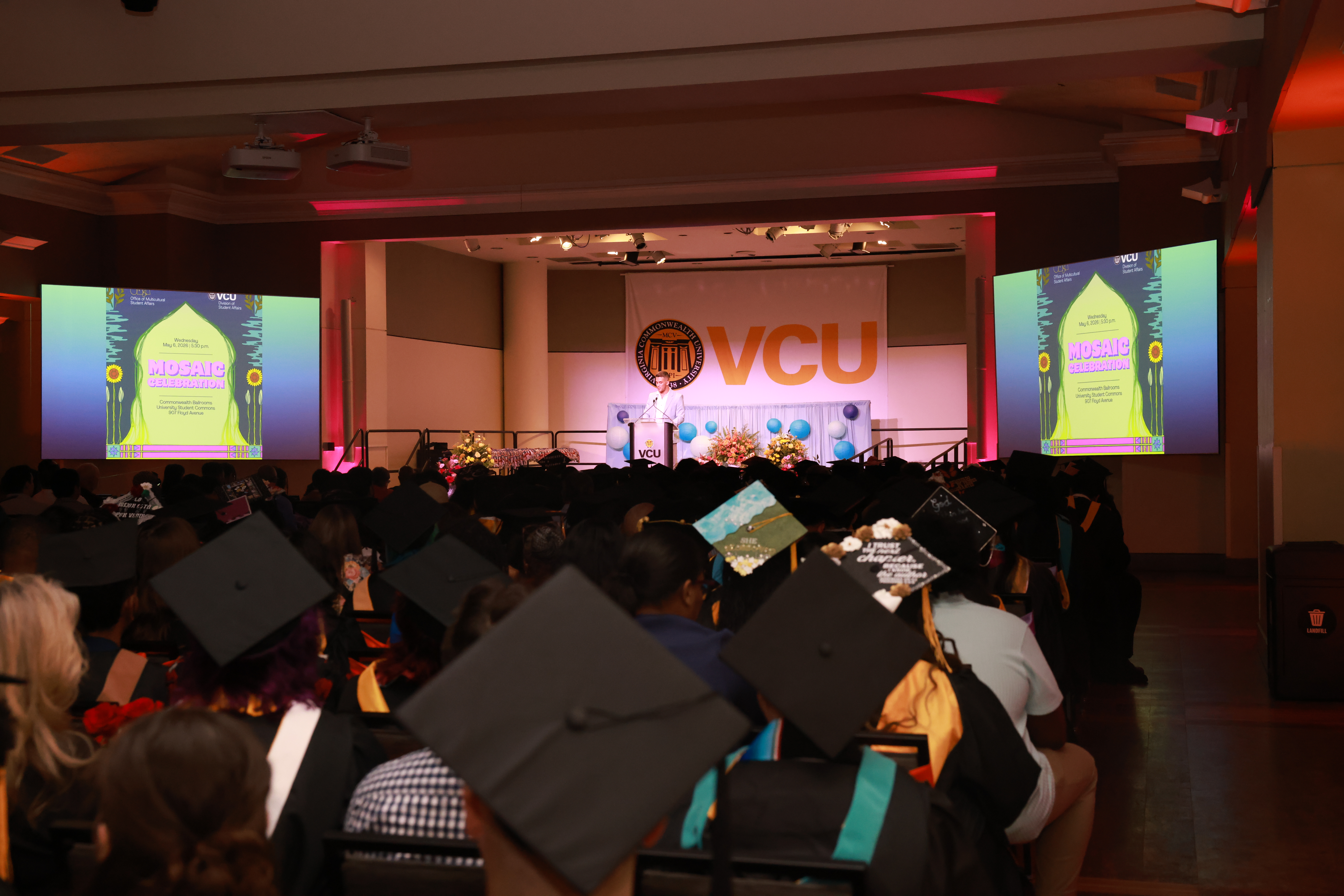 Audience at VCU Mosaic Celebration watches speaker on stage. Graduates ...