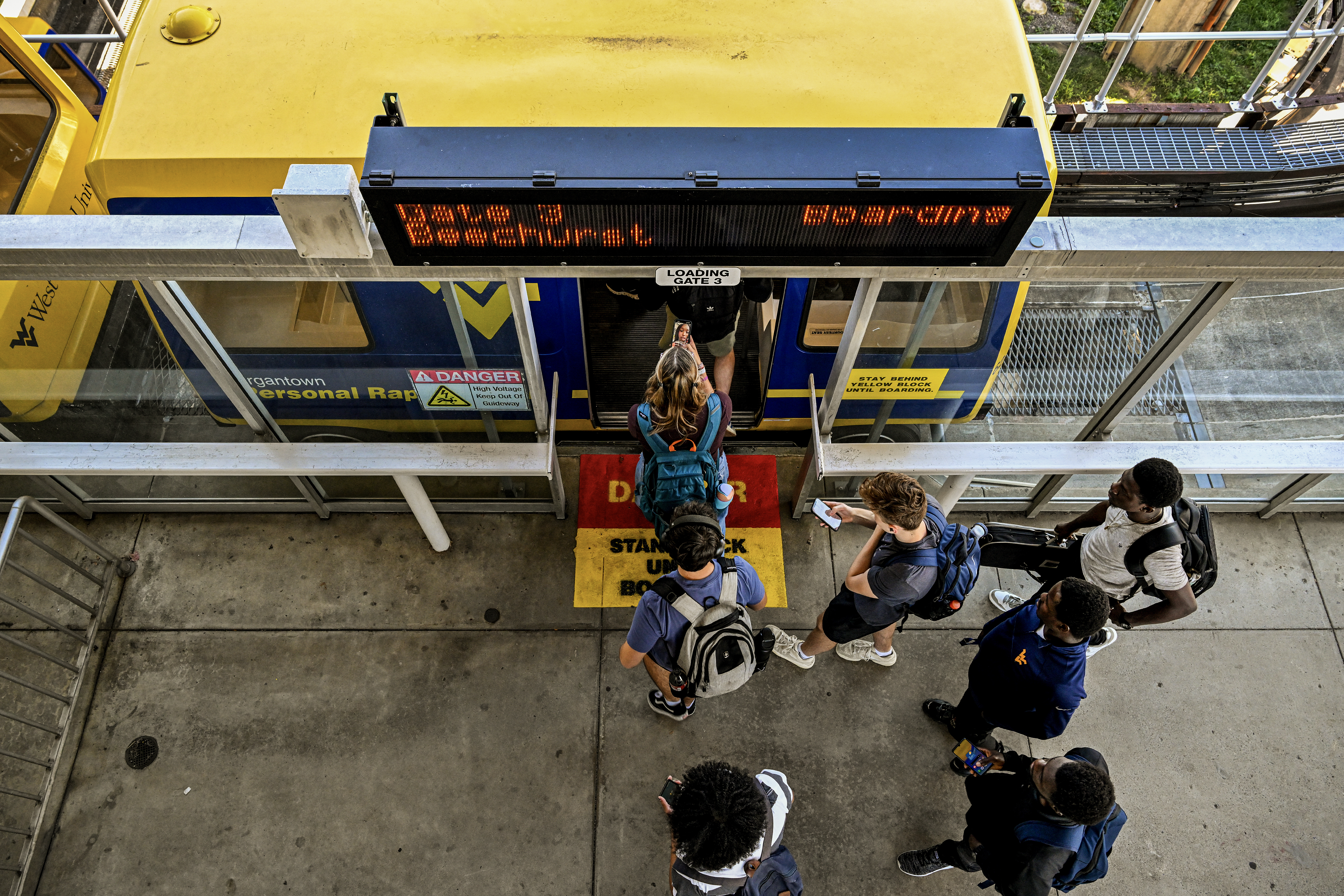 Students board the PRT at the Beechurst Station.