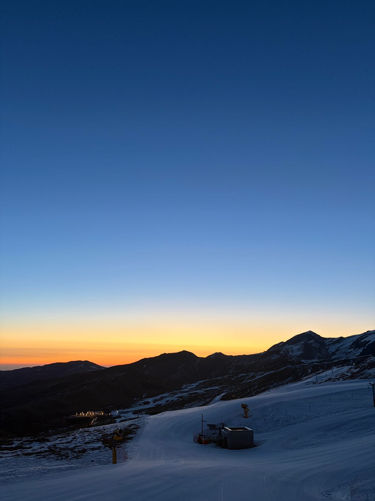 Sunset over snowy mountains in KSAB, Azerbaijan. The sky fades from ...