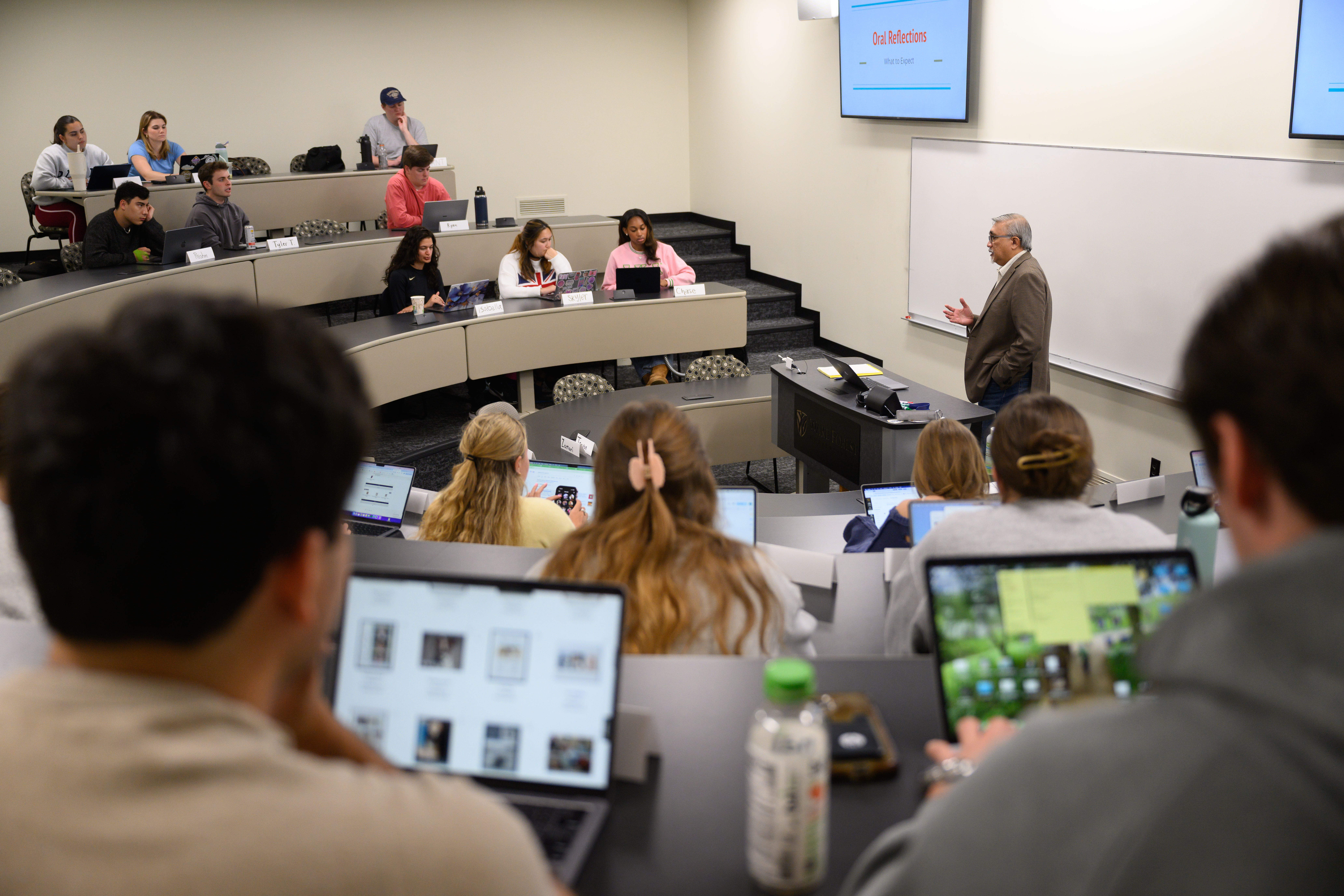 Chase Clark ('26) attends a lecture in a tiered classroom. The ...