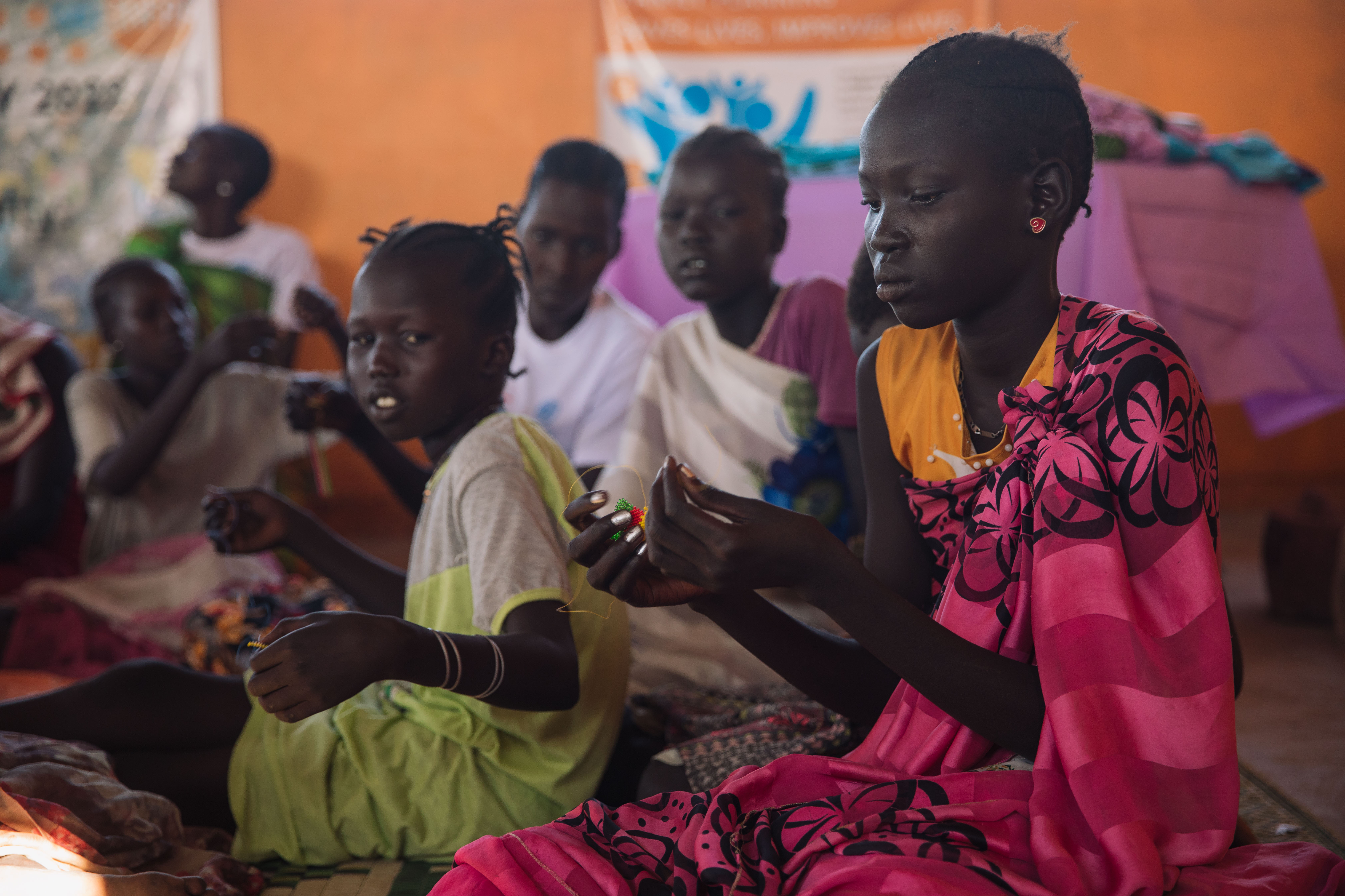 Girls make beaded jewelry at the WGFS in Bentiu IDP Site. Photo: OCHA ...
