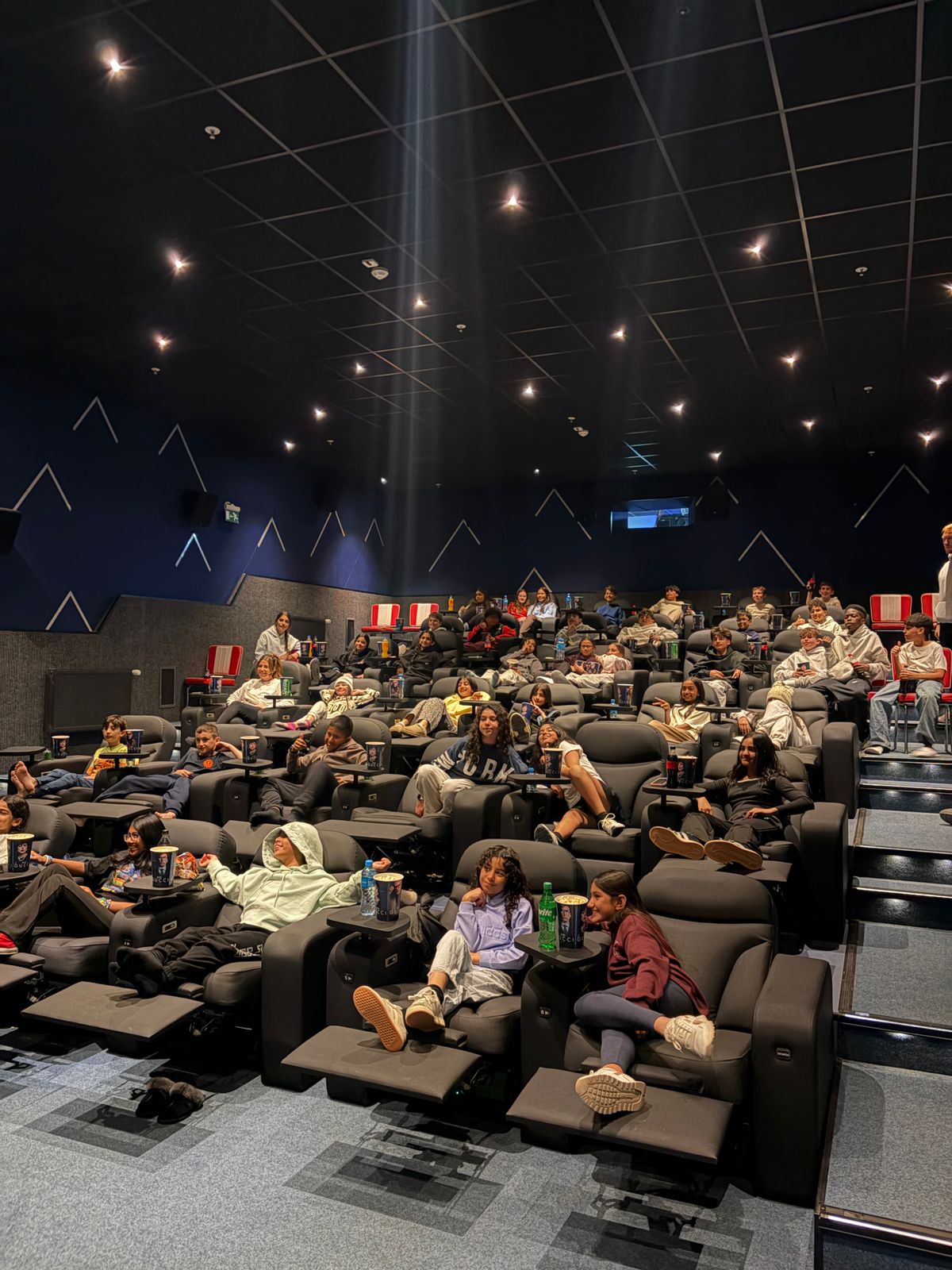 People relax in reclining seats at a KSAB movie theater in Azerbaijan ...