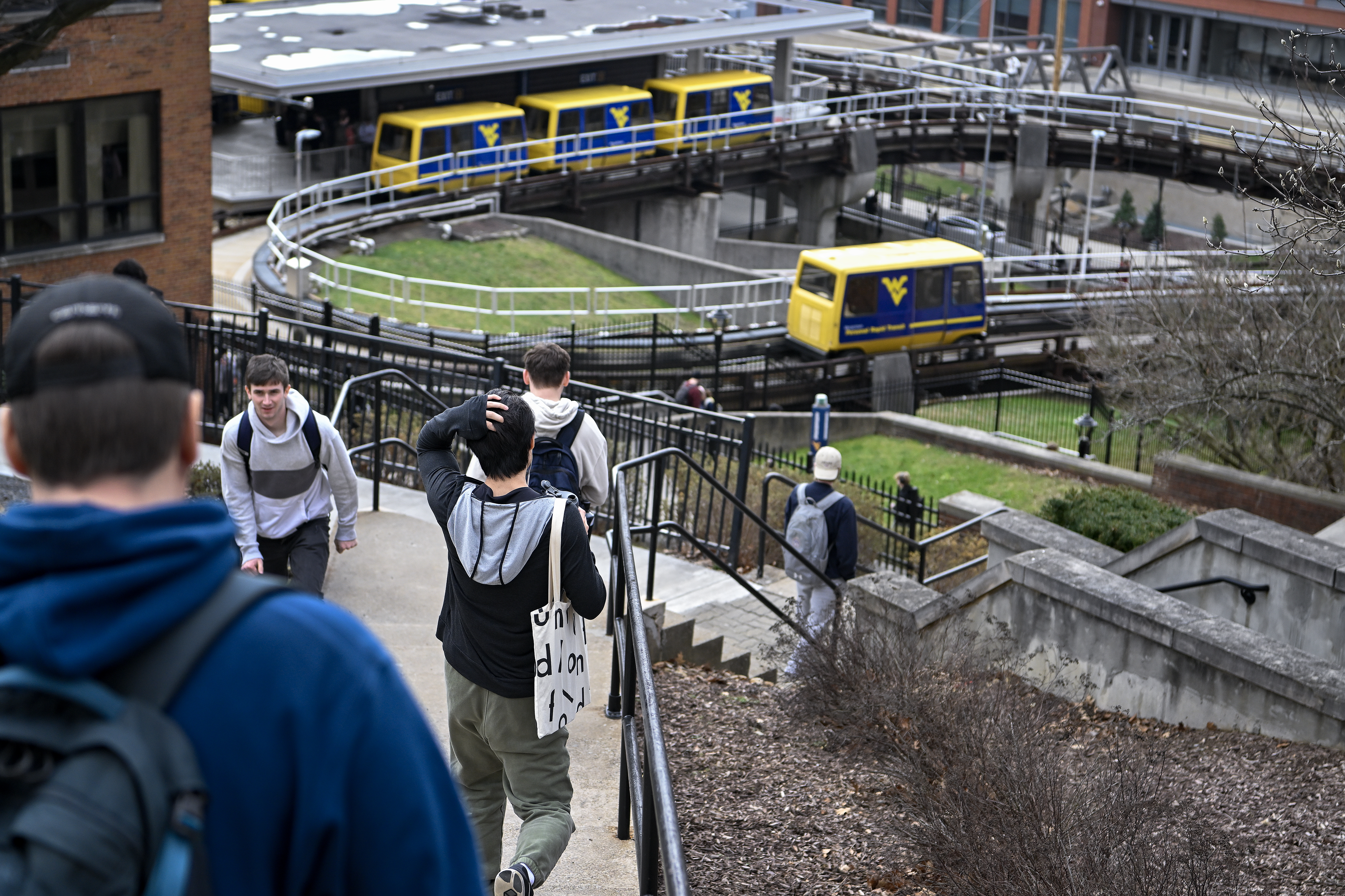 Students roam up and down the steps at the Beechurst PRT Station.