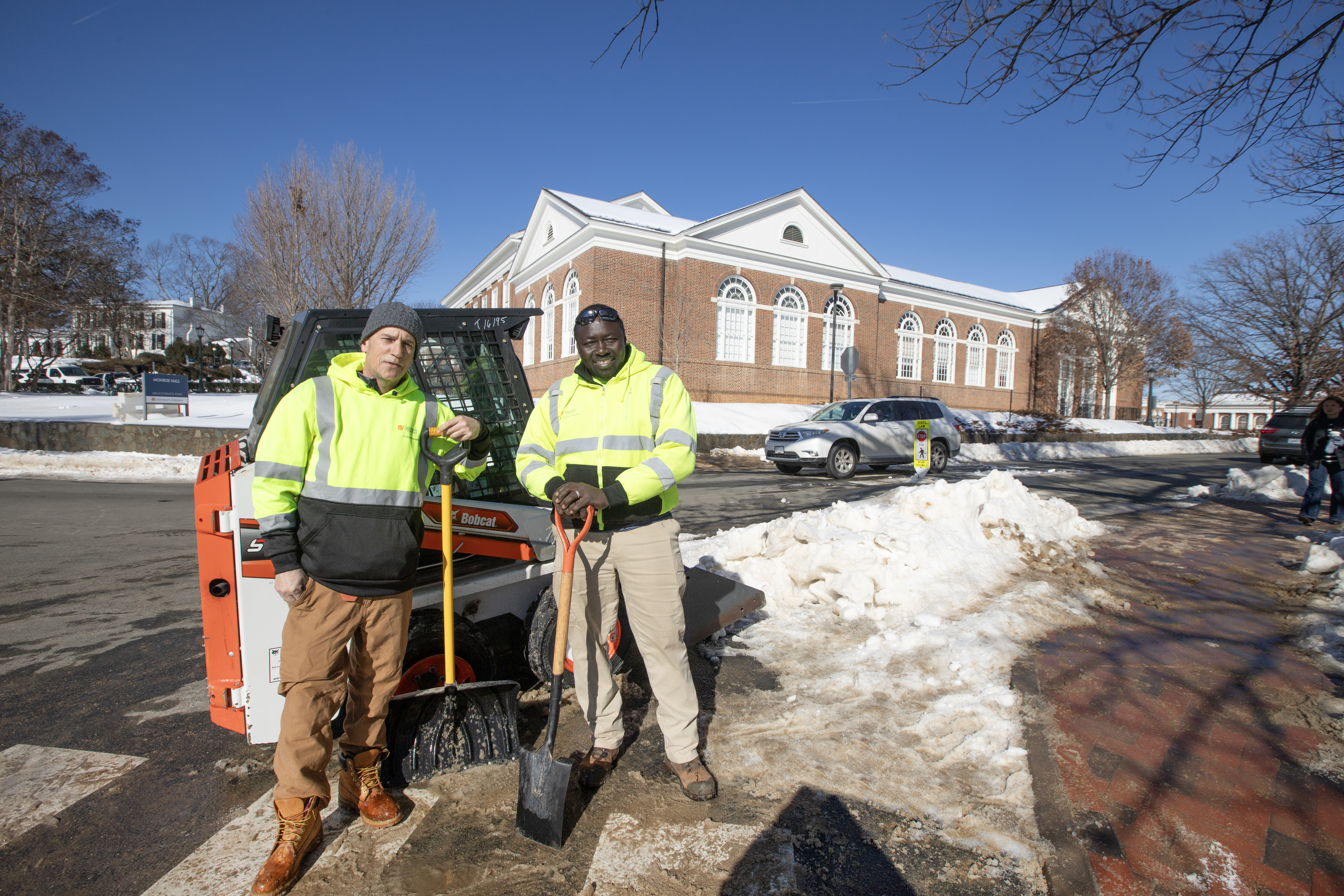 Senior Landscapers Lance Gentry and Abdalla Mohamed clear ice along ...