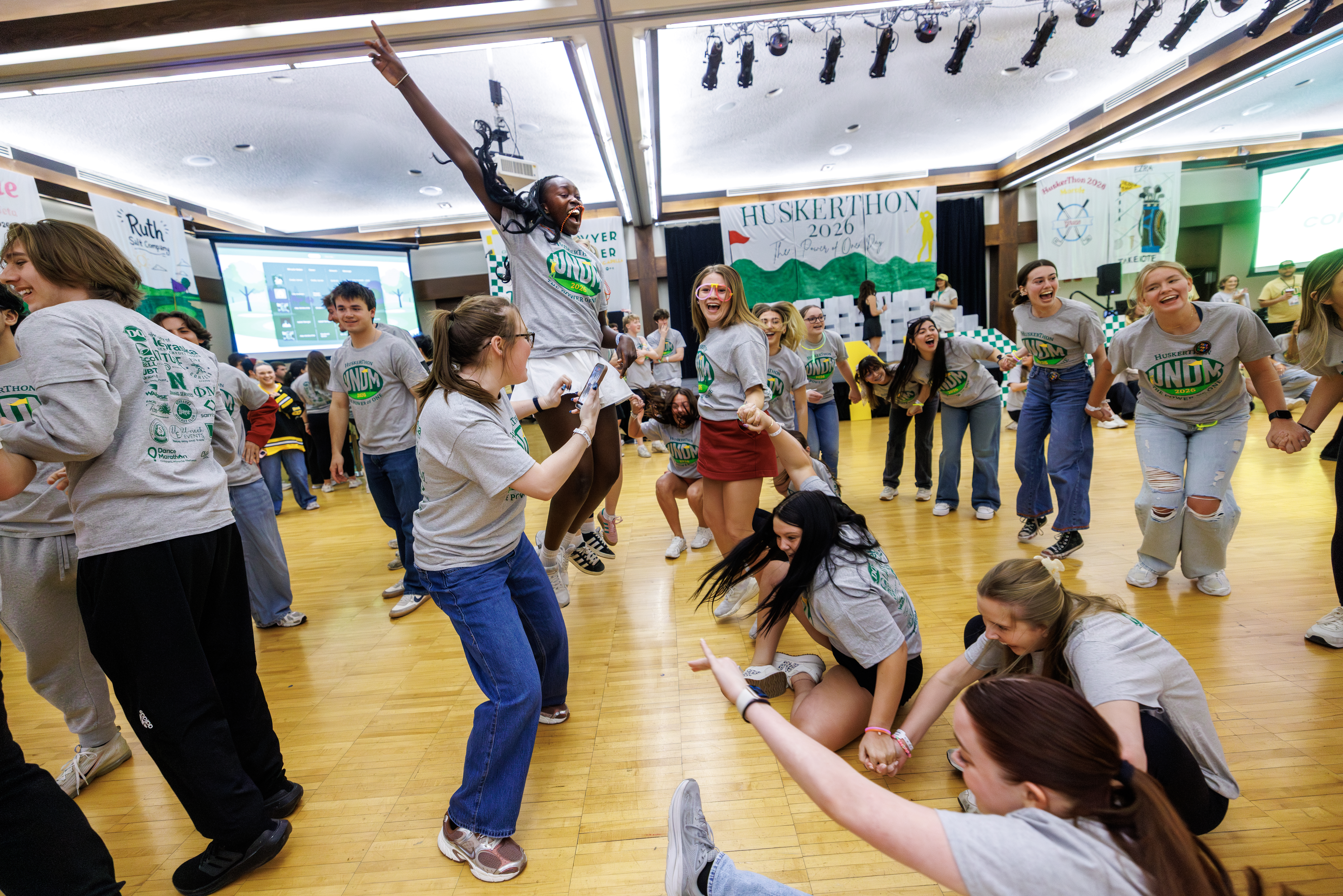 Students celebrate winning the Hula Hoop Line game at Huskerthon inside ...