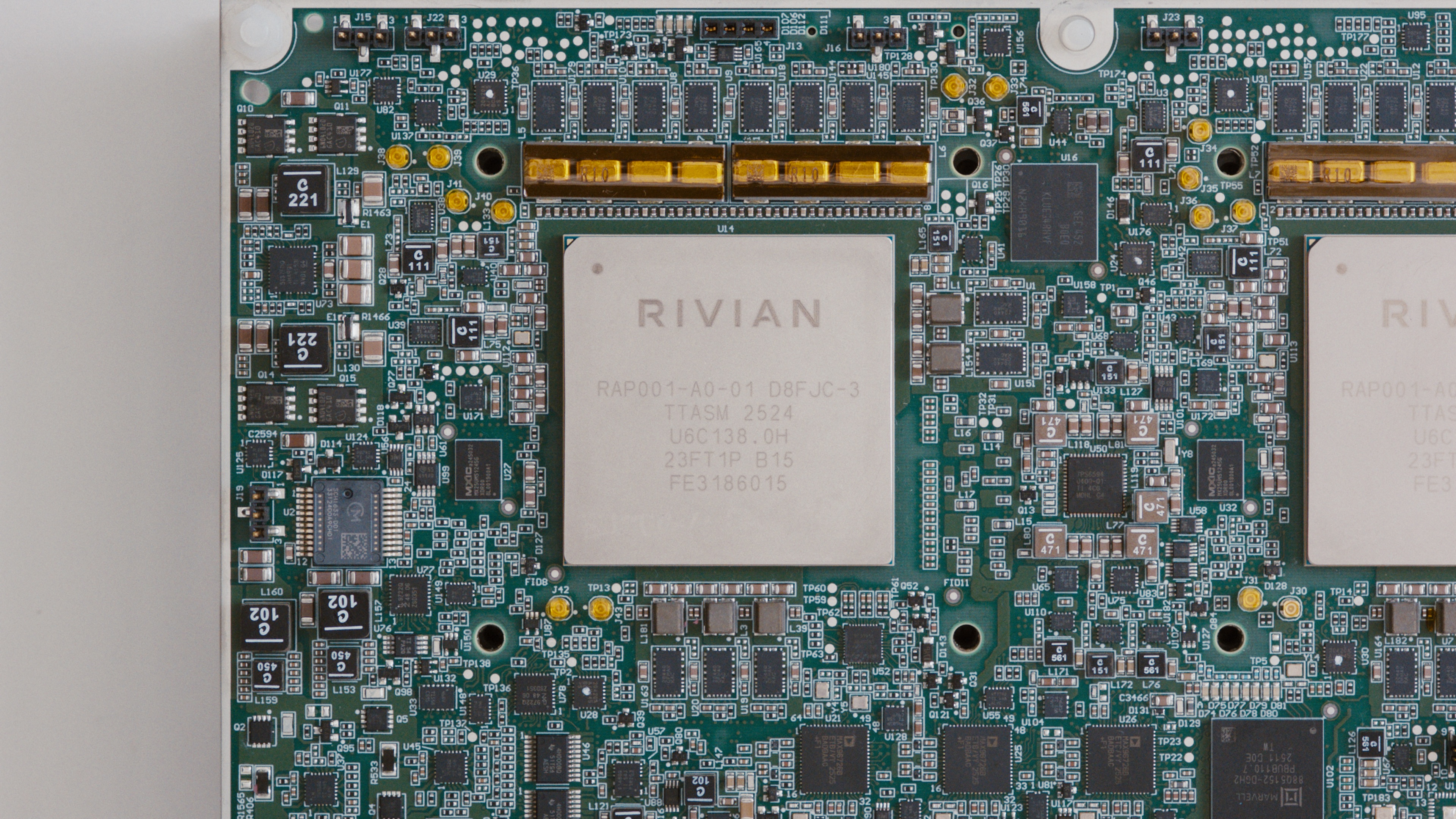 Close-up of a green Rivian circuit board, labeled