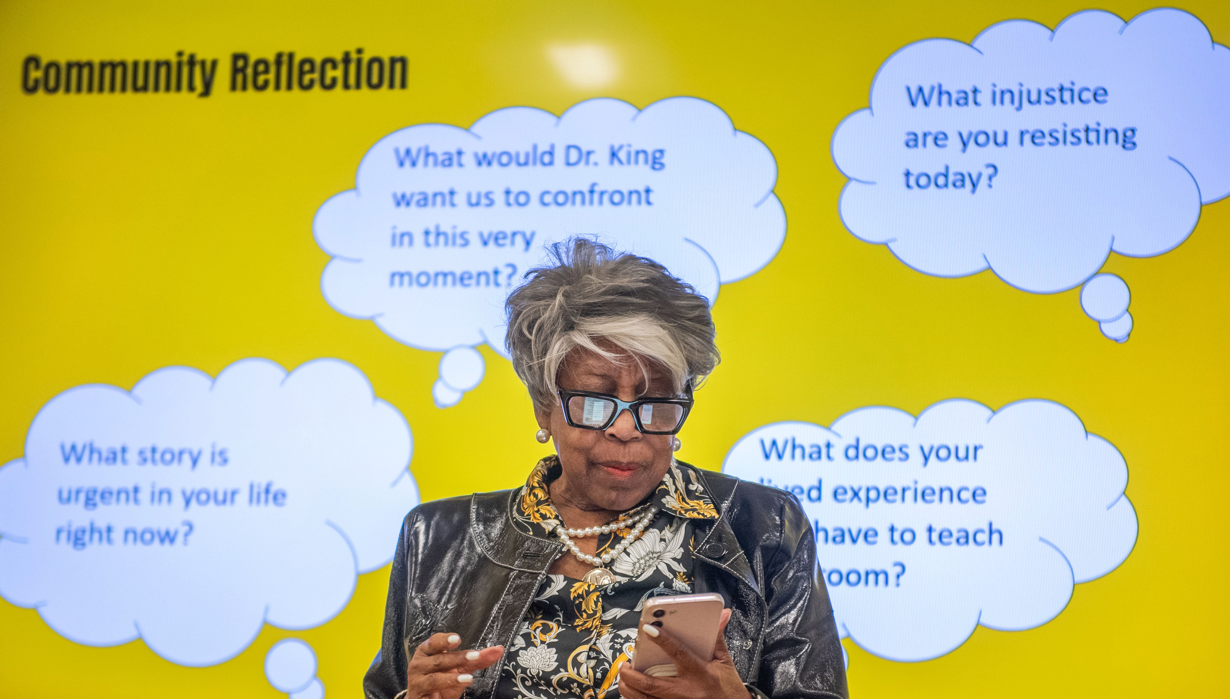 Lillian Cross shares thoughts at VCU Health Hub. She looks at her phone ...