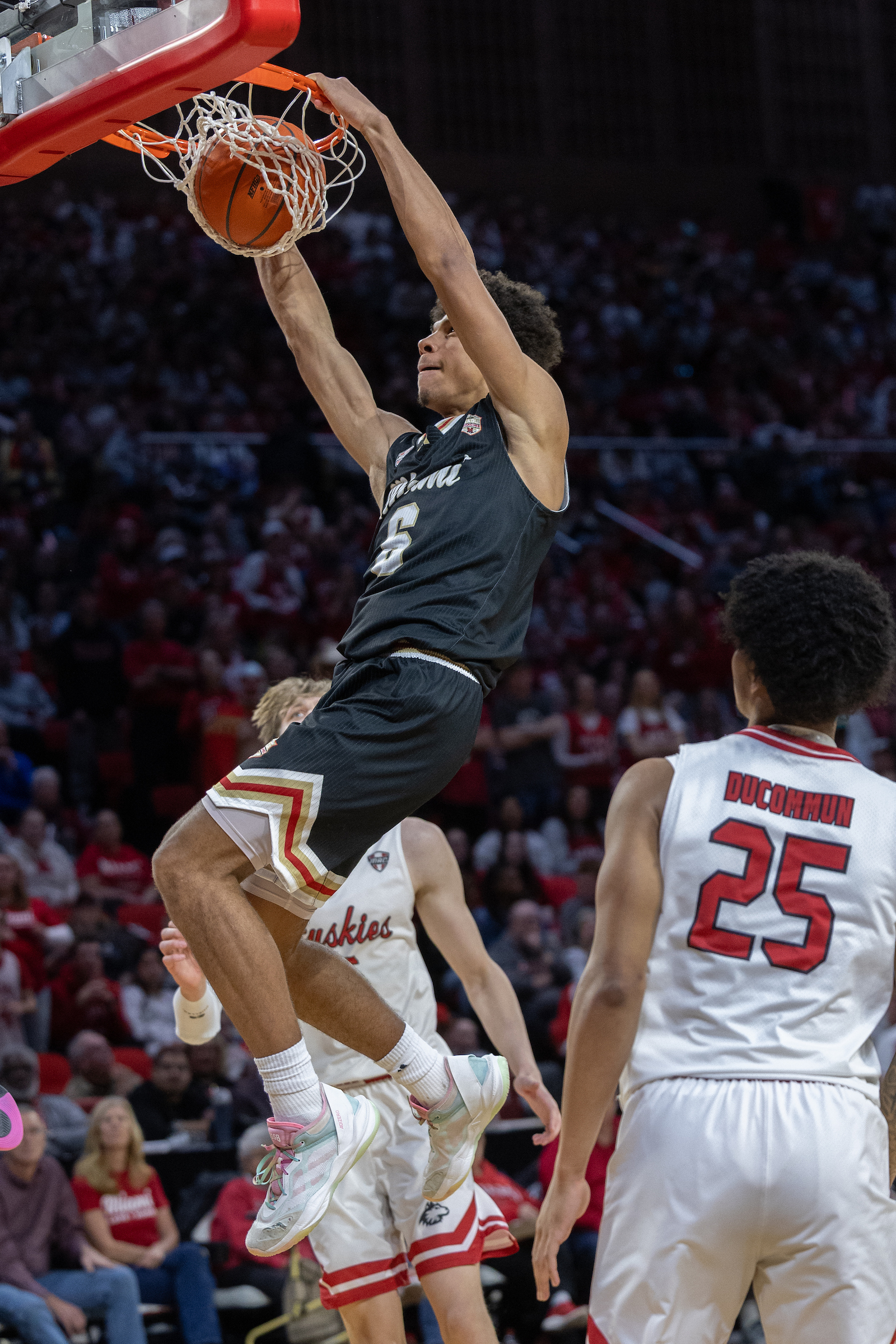 Miami basketball player in black uniform dunks the ball during One ...