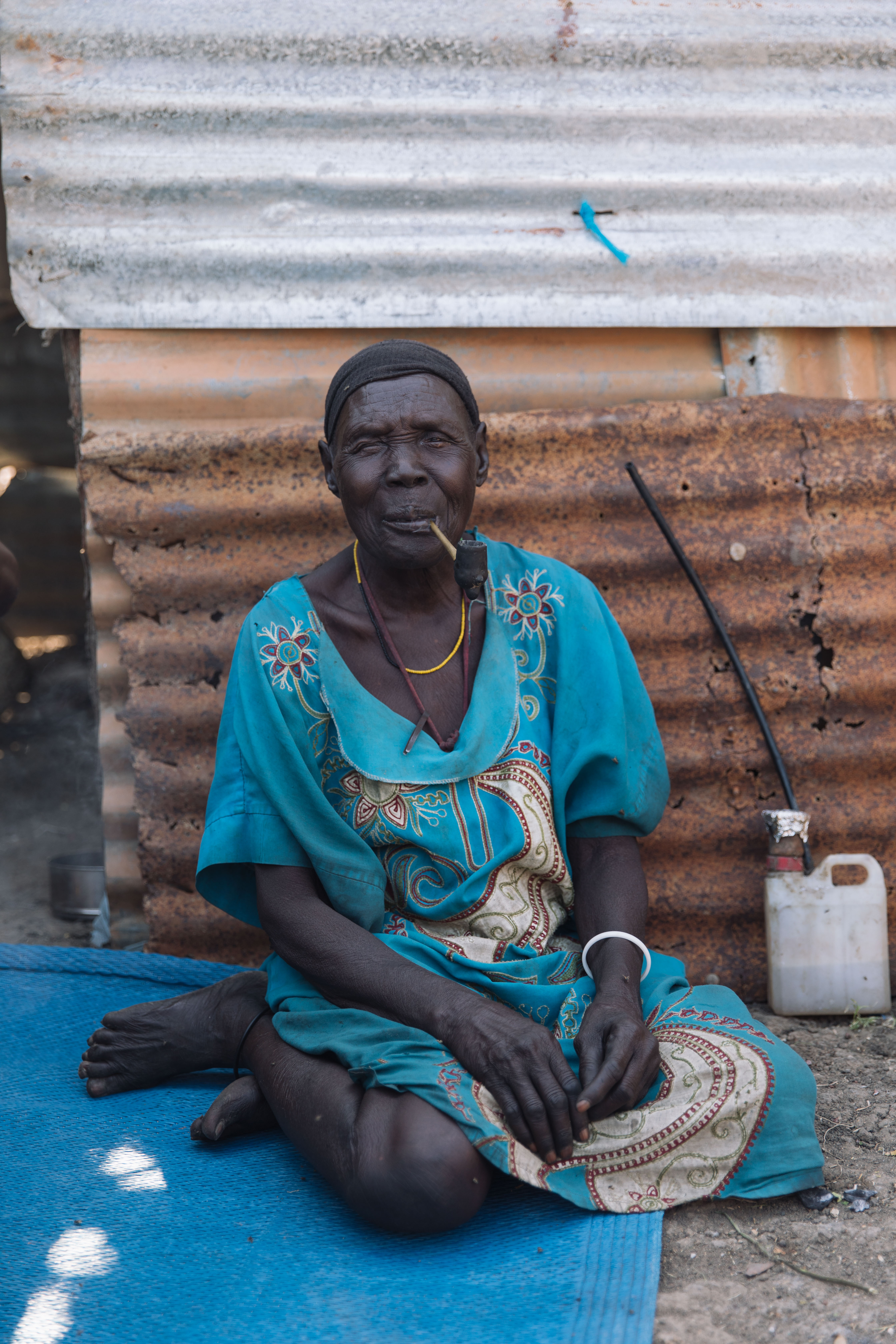 Nyabor Manyun Poul outside her shelter in the Fire Brigade IDP site in ...