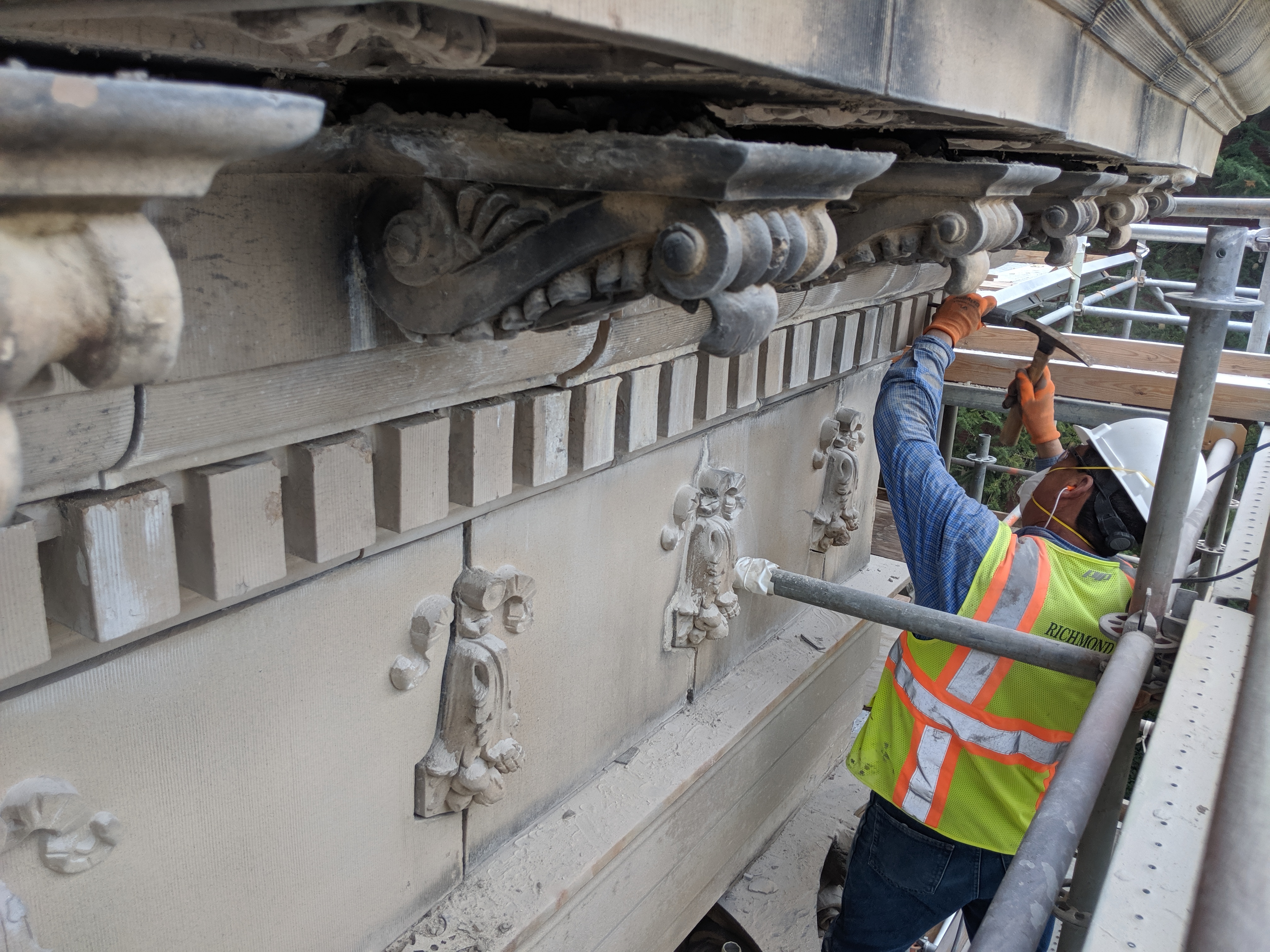 A construction worker renovating the exterior masonry at the Scott House.